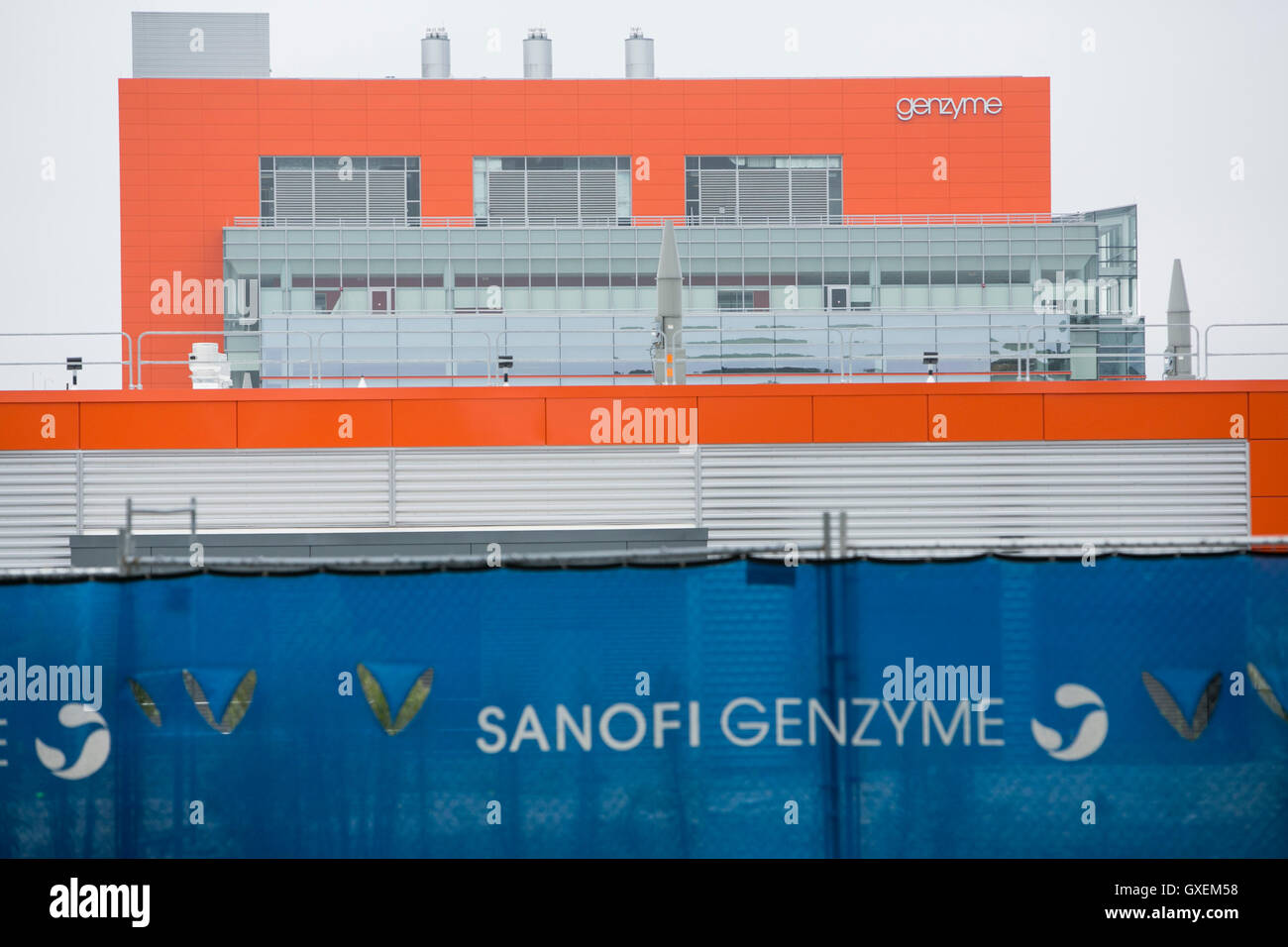 A logo sign outside of a facility occupied by the Genzyme Corporation ...
