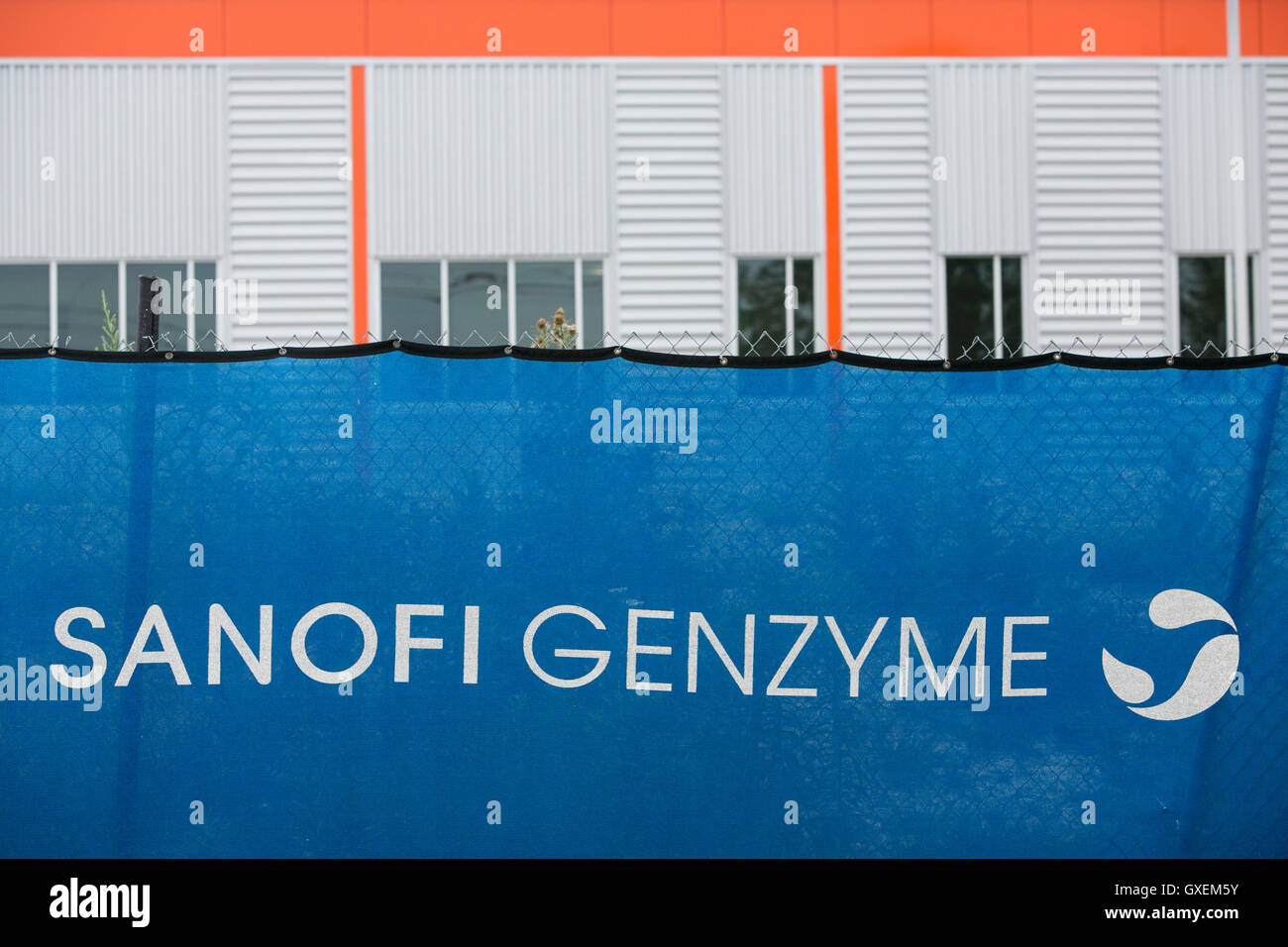 A logo sign outside of a facility occupied by the Genzyme Corporation ...
