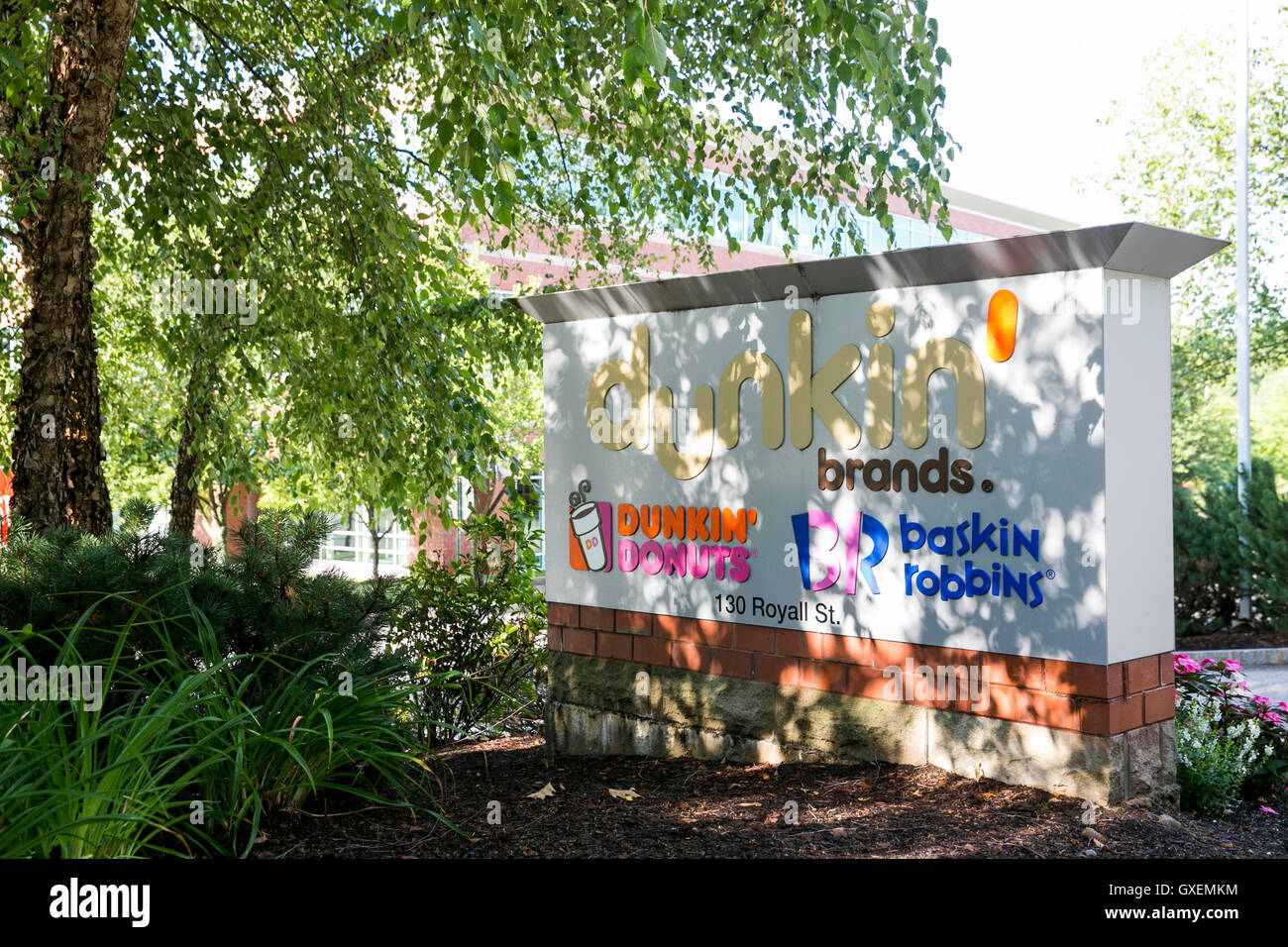 A logo sign outside of the headquarters of Dunkin' Brands Group, Inc ...