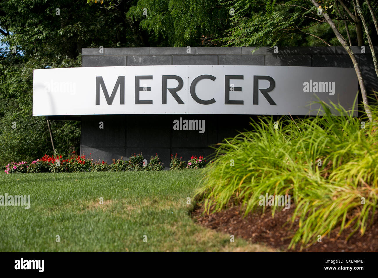 A logo sign outside of a facility occupied by Mercer in Norwood ...