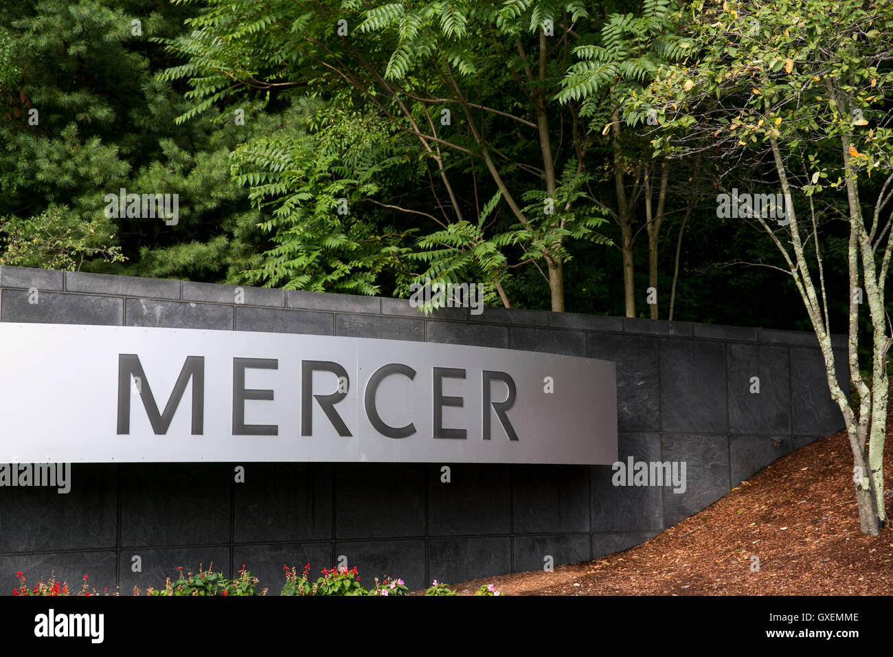 A logo sign outside of a facility occupied by Mercer in Norwood ...