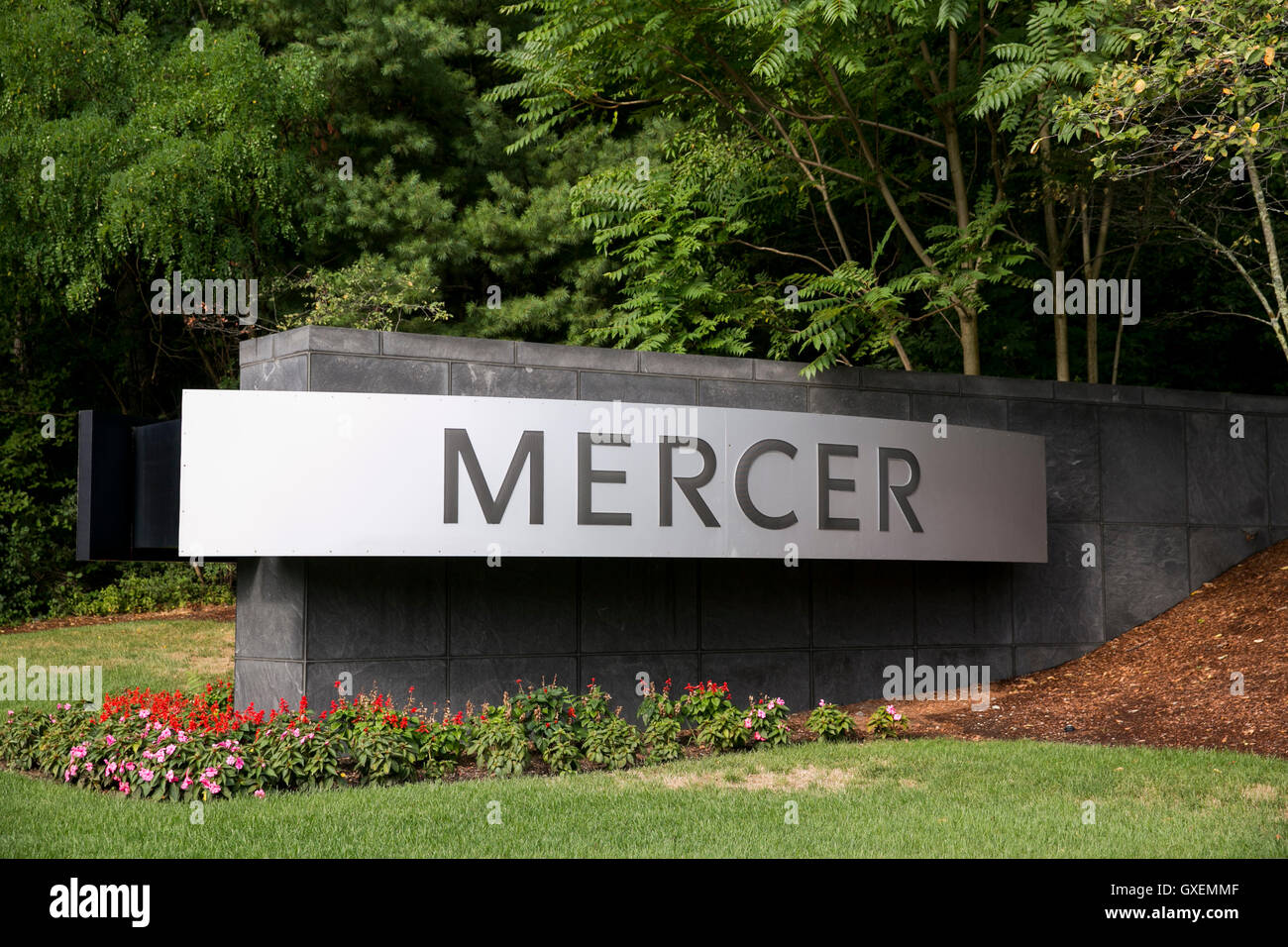 A logo sign outside of a facility occupied by Mercer in Norwood ...