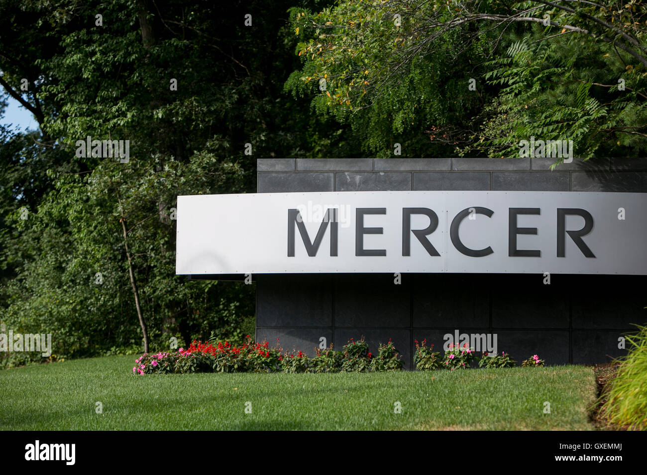 A logo sign outside of a facility occupied by Mercer in Norwood ...