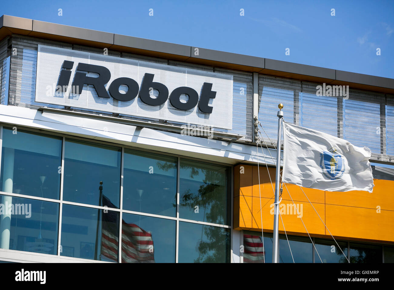 A logo sign outside of the headquarters of the iRobot Corporation in ...