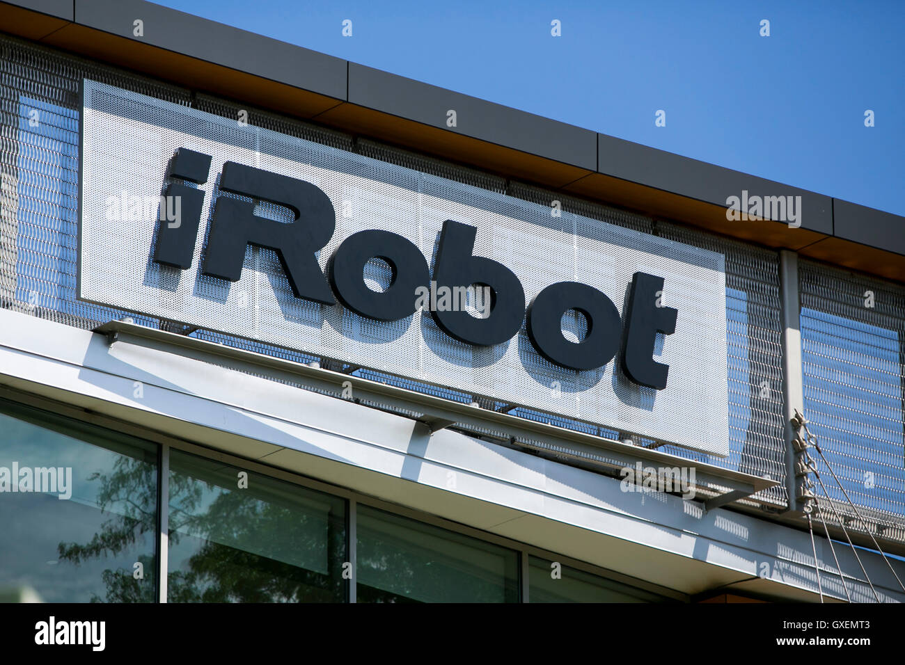 A logo sign outside of the headquarters of the iRobot Corporation in ...
