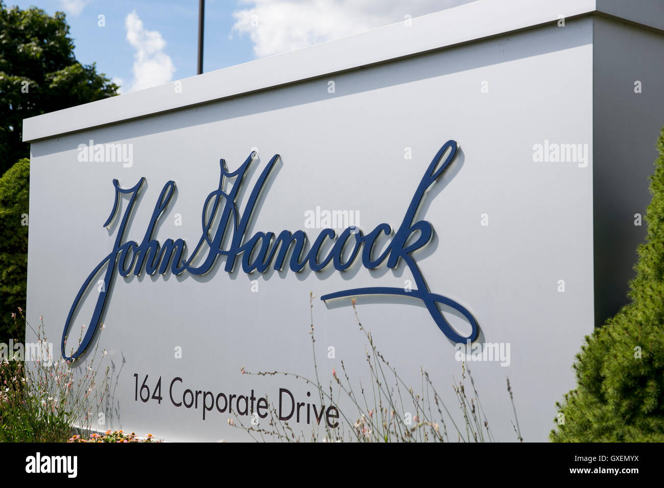 A logo sign outside of a facility occupied by John Hancock Financial in ...