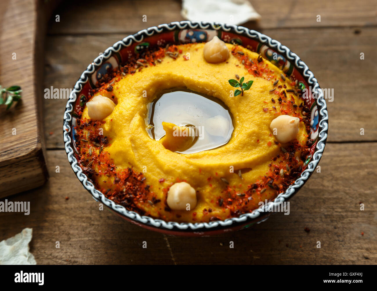 pumpkin thume hummus on a white wood background. the toning. selective ...