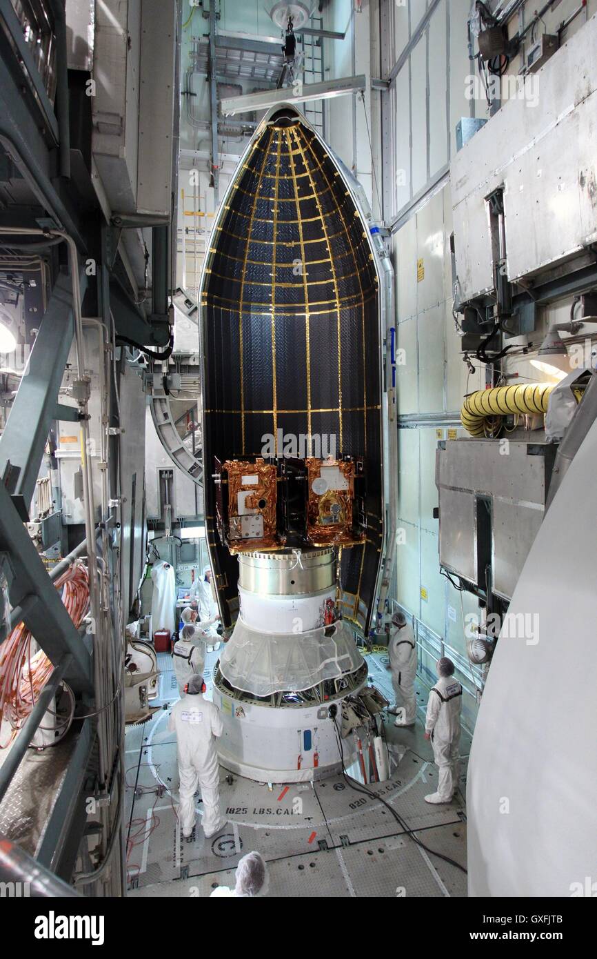 NASA spacecraft technicians monitor the movement of a section of Delta ...