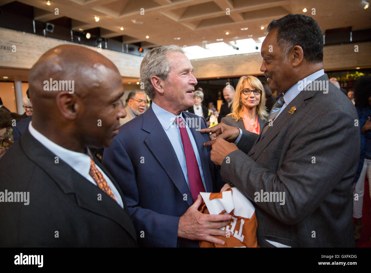 Former U.S. President George W. Bush talks to Rev. Jesse Jackson during ...
