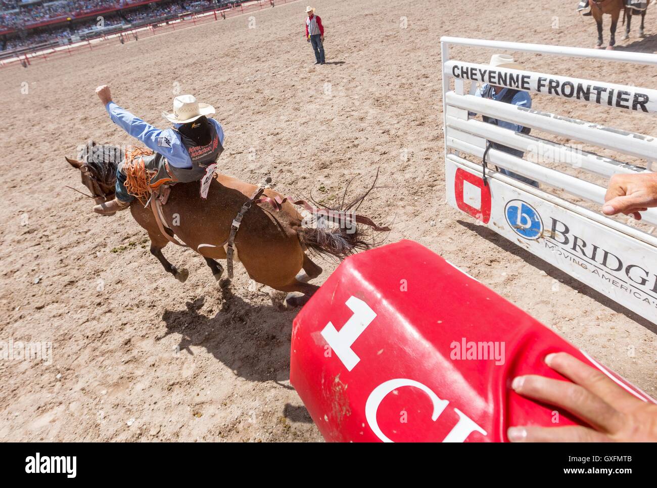 A bareback rider hangs on during rodeo competition at Cheyenne Frontier ...