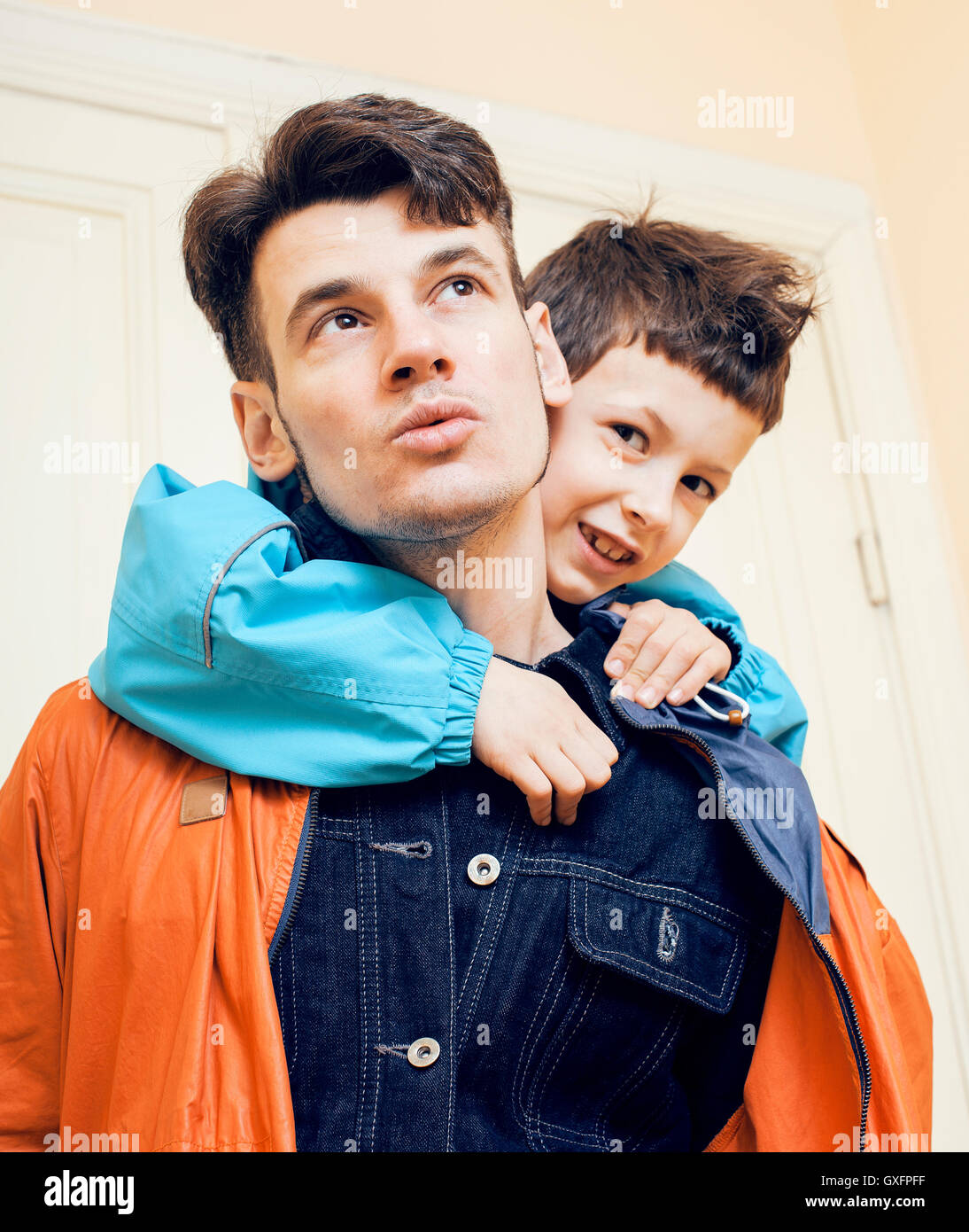 young handsome father with his son fooling around at home, lifestyle ...
