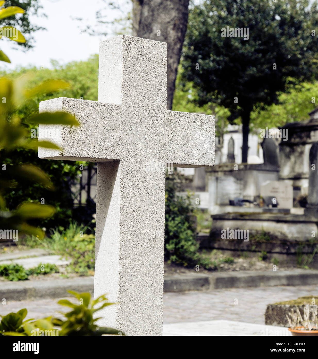 Tombstones in cemetery at dusk, gothic style crosses Stock Photo - Alamy