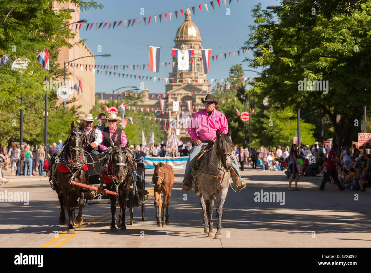 Cowboys riding during the Cheyenne Frontier Days parade past the state ...