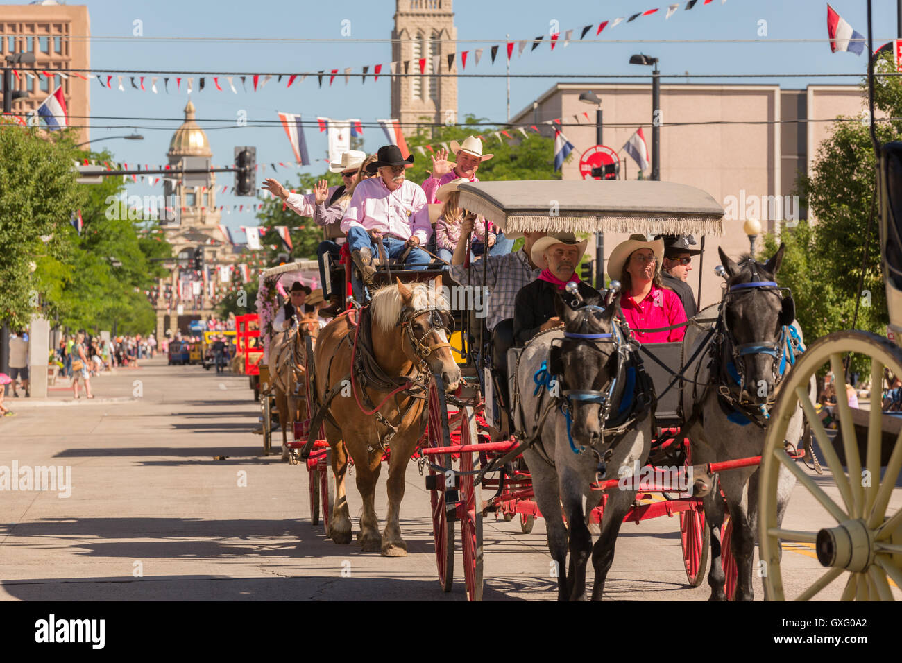 Cowboys riding during the Cheyenne Frontier Days parade past the state ...