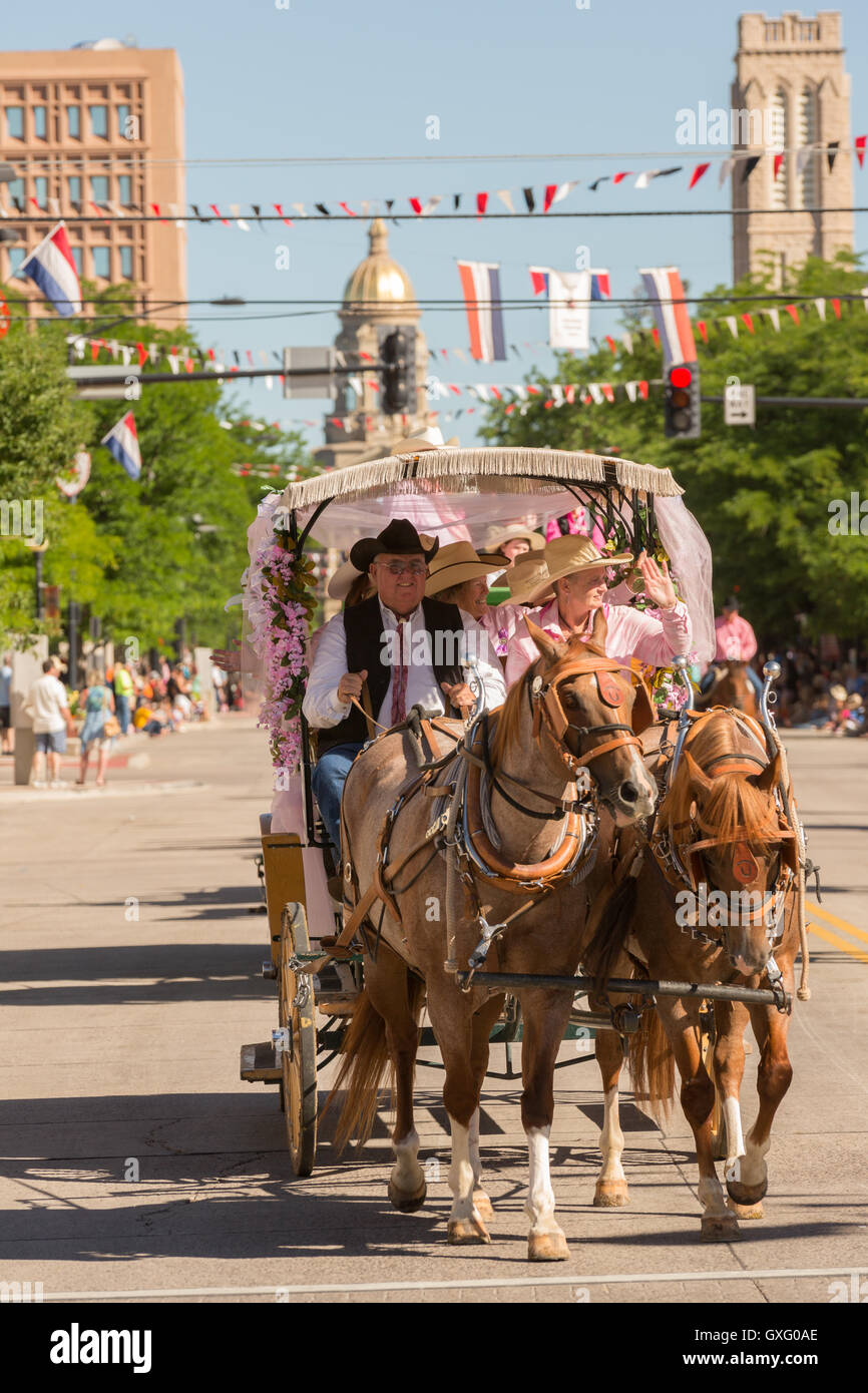 Cowboys riding during the Cheyenne Frontier Days parade past the state ...