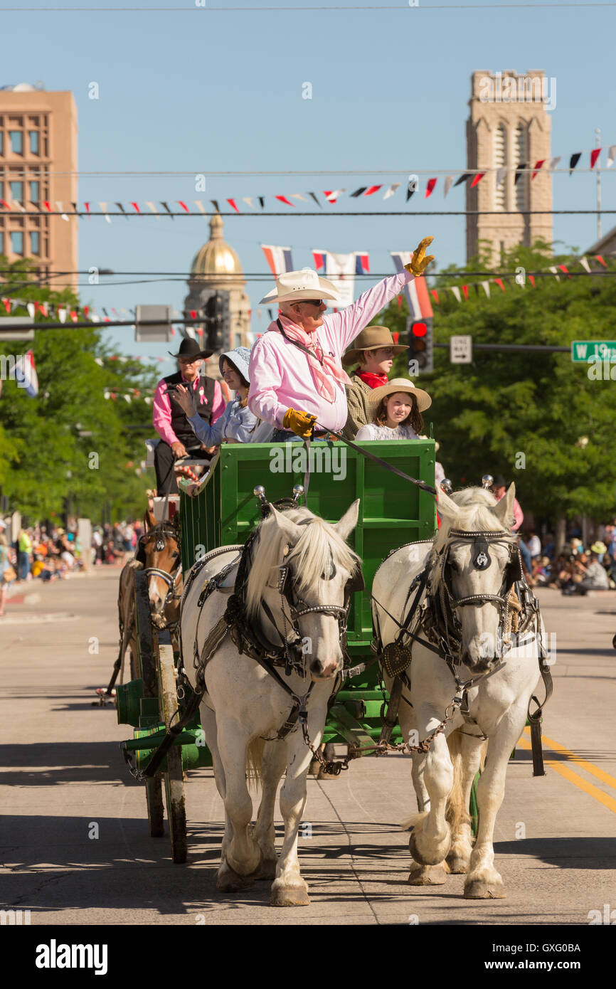 Cowboys riding during the Cheyenne Frontier Days parade past the state ...