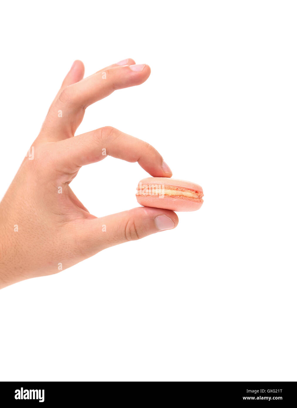Hand holds traditional pink macaron Stock Photo - Alamy