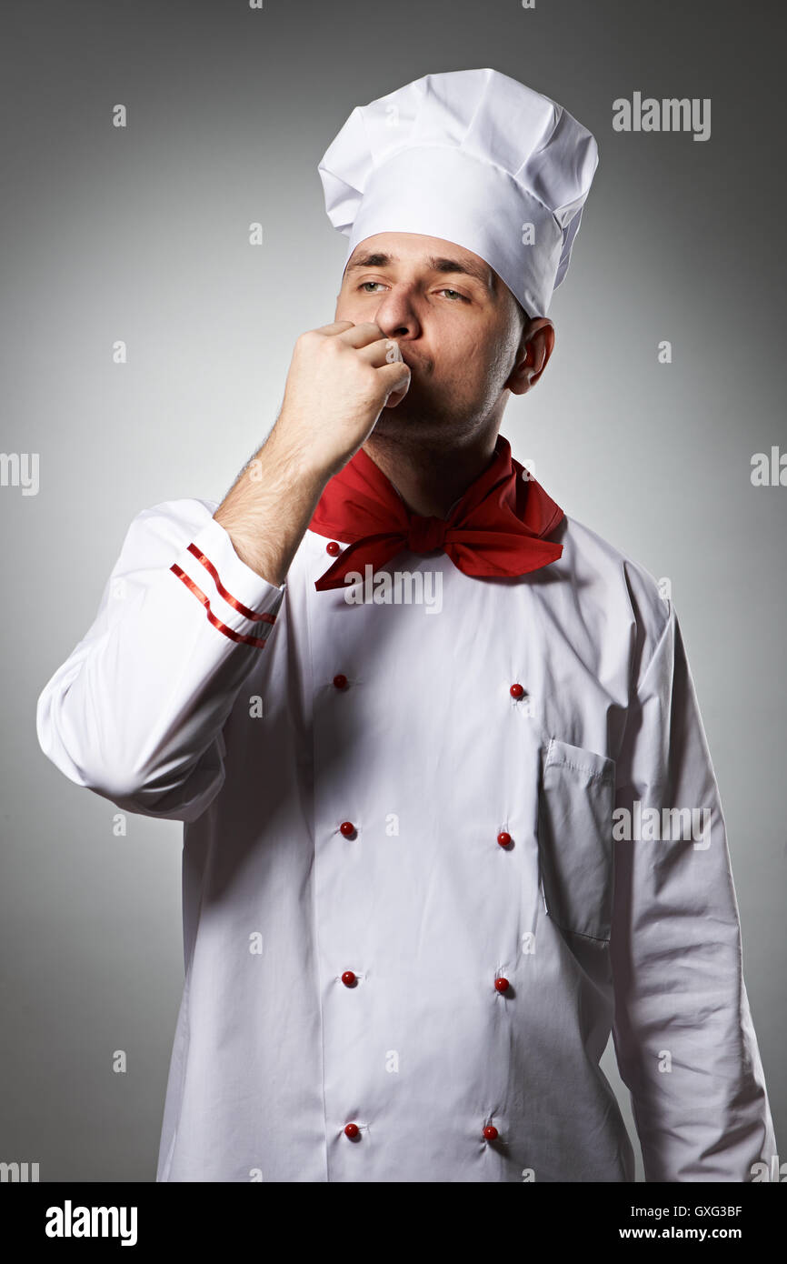 Male chef kissing fingers Stock Photo - Alamy