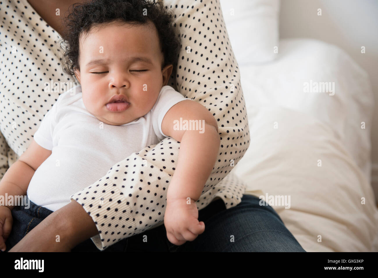 Baby boy sleeping in lap hi-res stock photography and images - Alamy