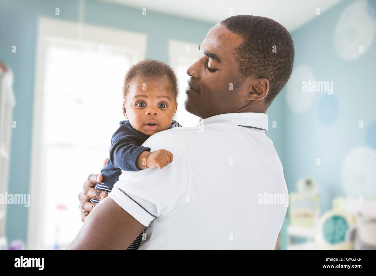 Black father holding baby son Stock Photo - Alamy
