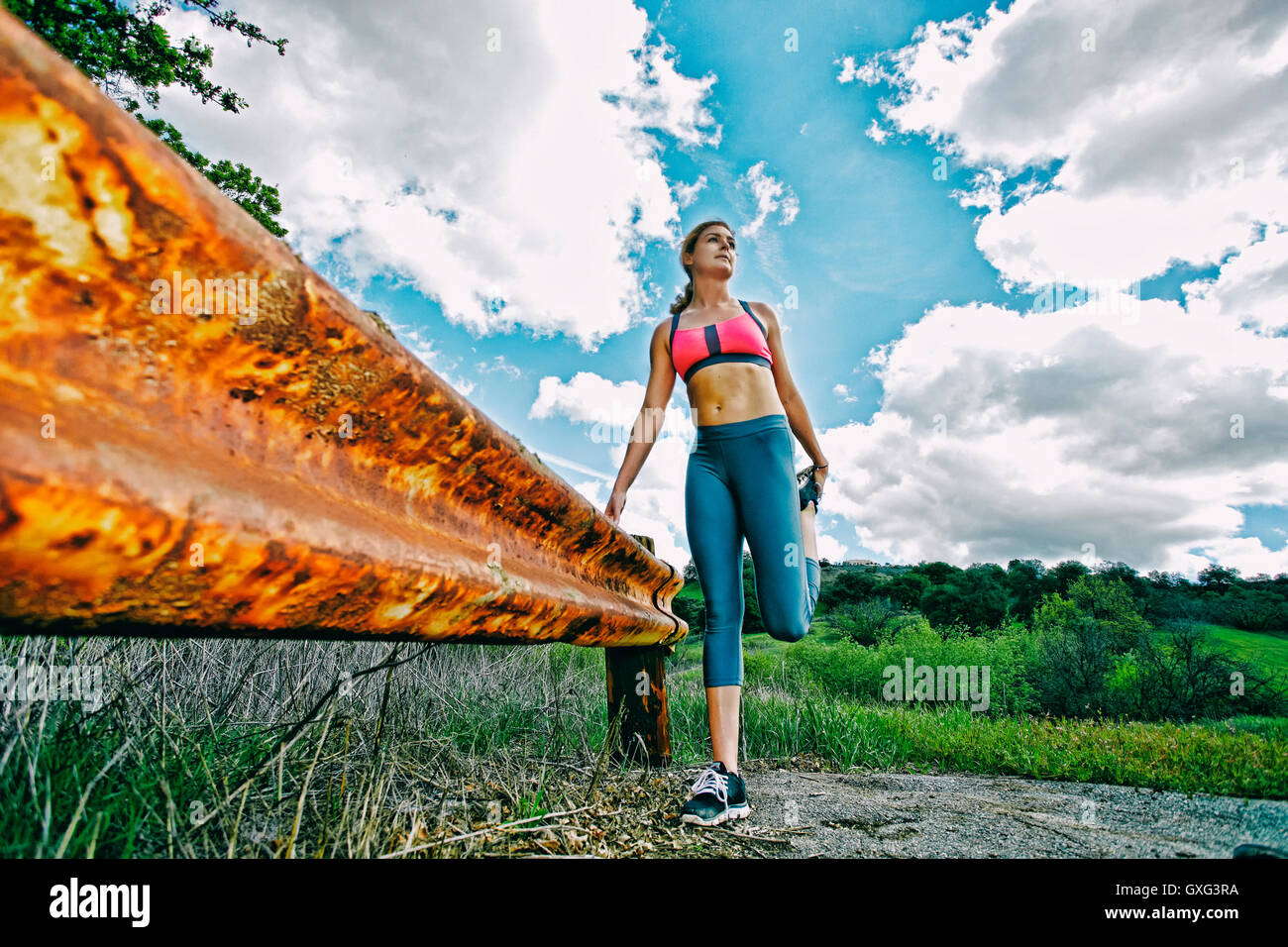 Fence stretching leg brunette hi-res stock photography and images - Alamy