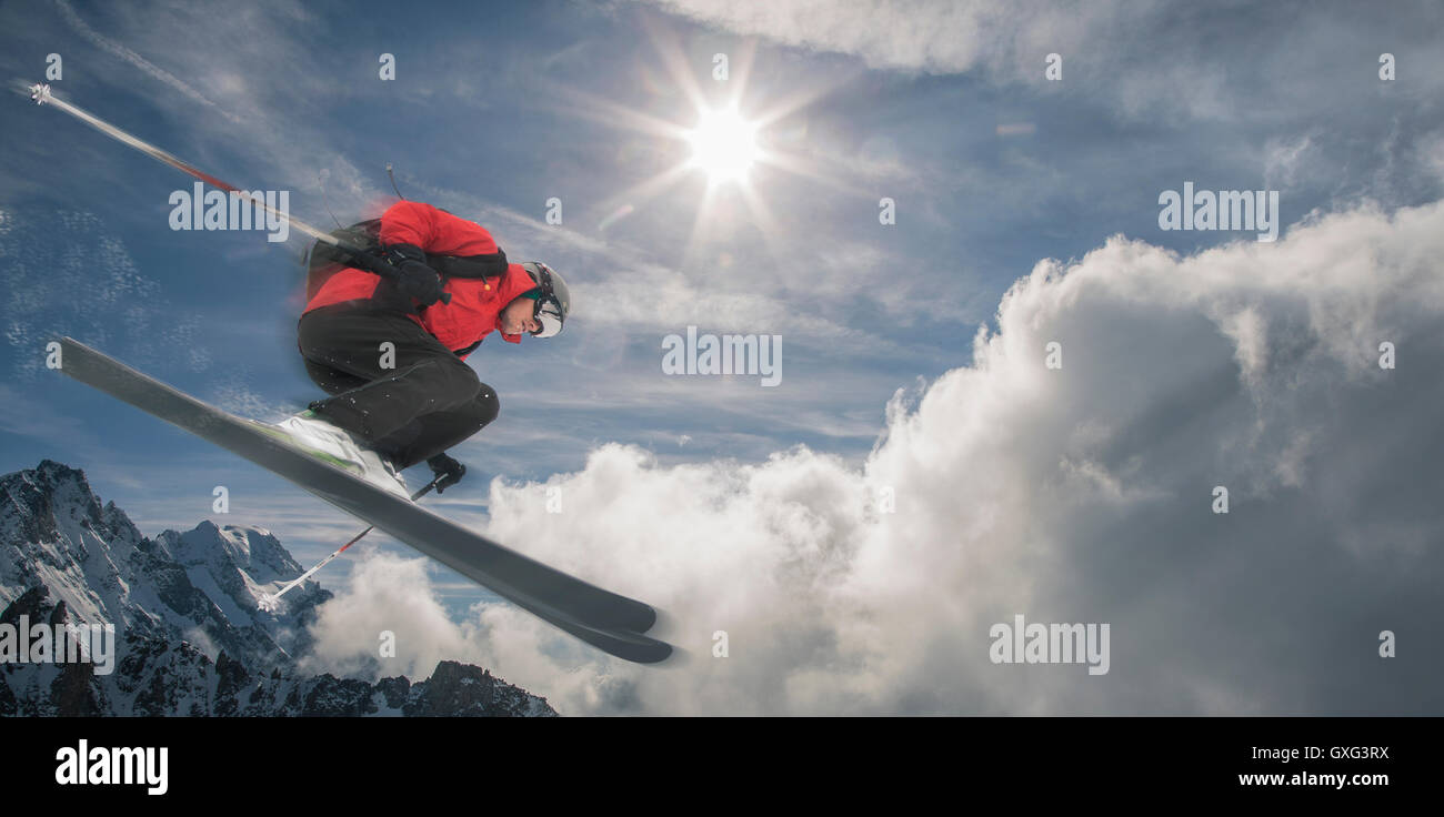 Caucasian skier jumping mid-air on mountain Stock Photo - Alamy