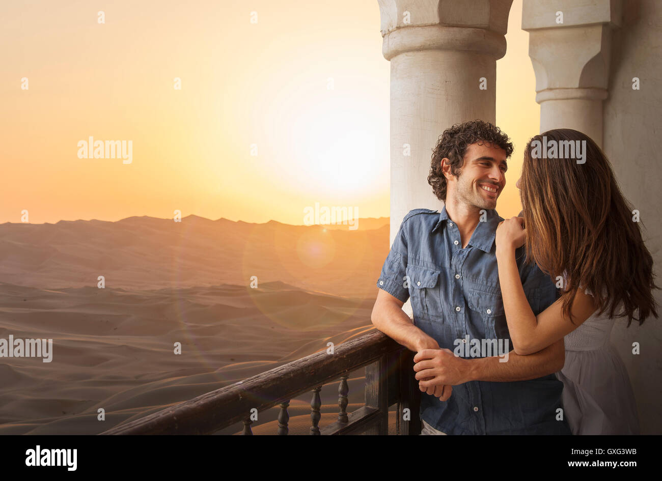 Smiling Caucasian couple on balcony in desert Stock Photo - Alamy