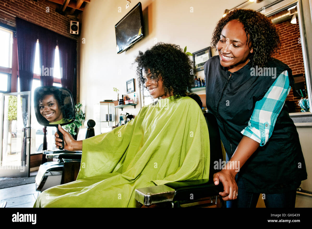 Smiling hairdresser and customer in hair salon Stock Photo - Alamy