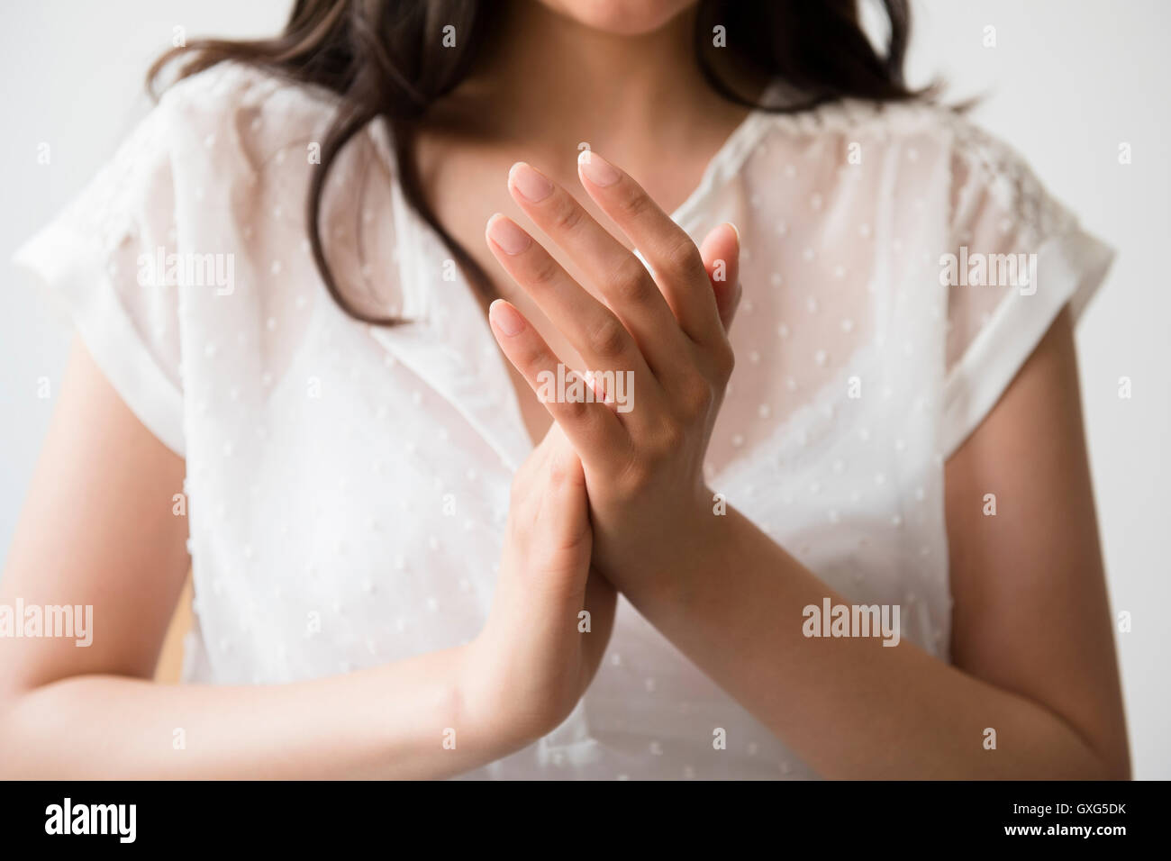 Woman rubbing hands hi-res stock photography and images - Alamy