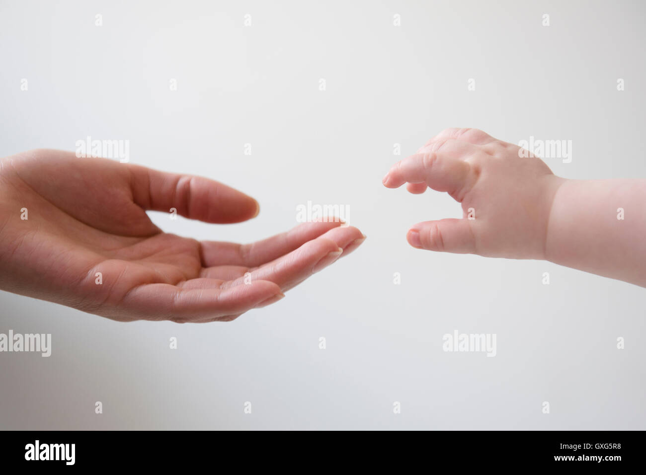 Hand of mother reaching for hand of baby son Stock Photo - Alamy