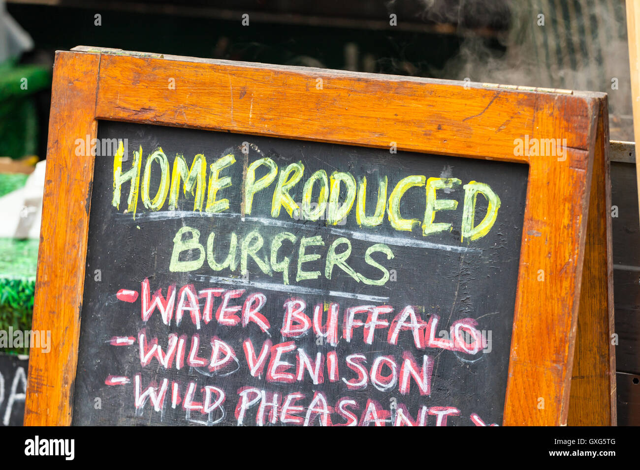Home produced burgers sign Stock Photo - Alamy