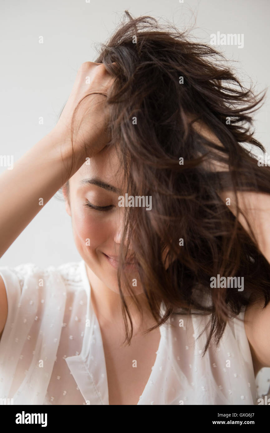 Hispanic woman tossing hair Stock Photo - Alamy