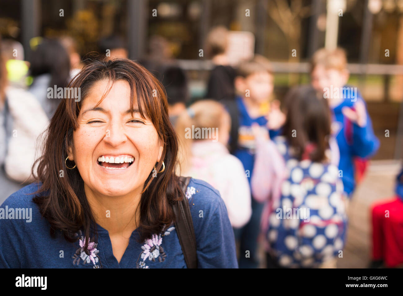 Hispanic woman laughing outdoors Stock Photo - Alamy