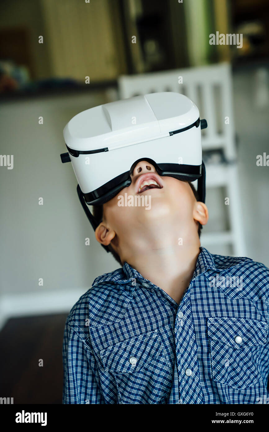 Caucasian boy wearing virtual reality goggles Stock Photo - Alamy