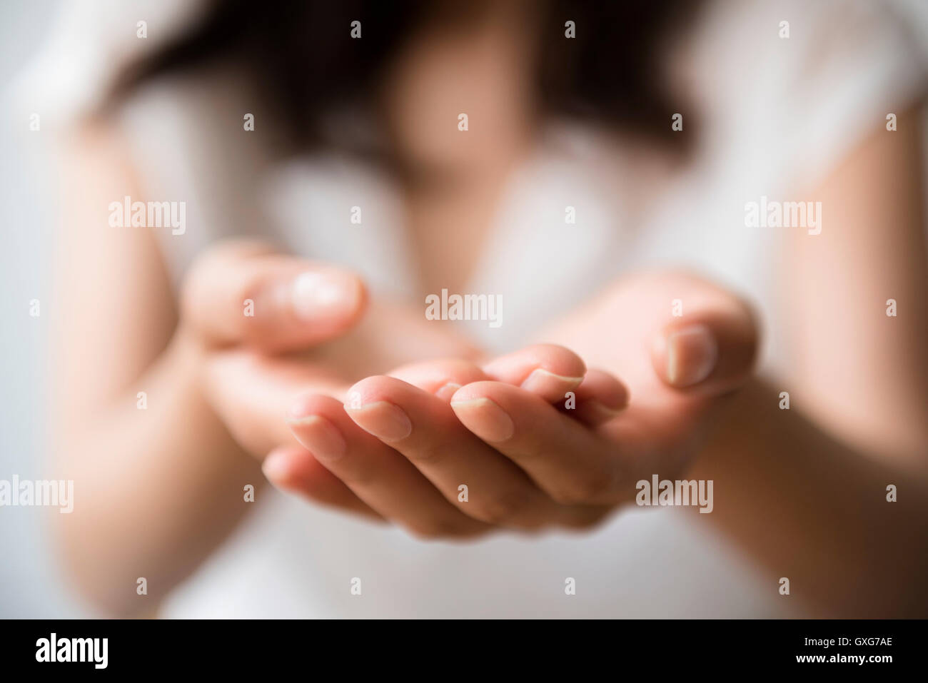 Hispanic woman cupping hands Stock Photo - Alamy