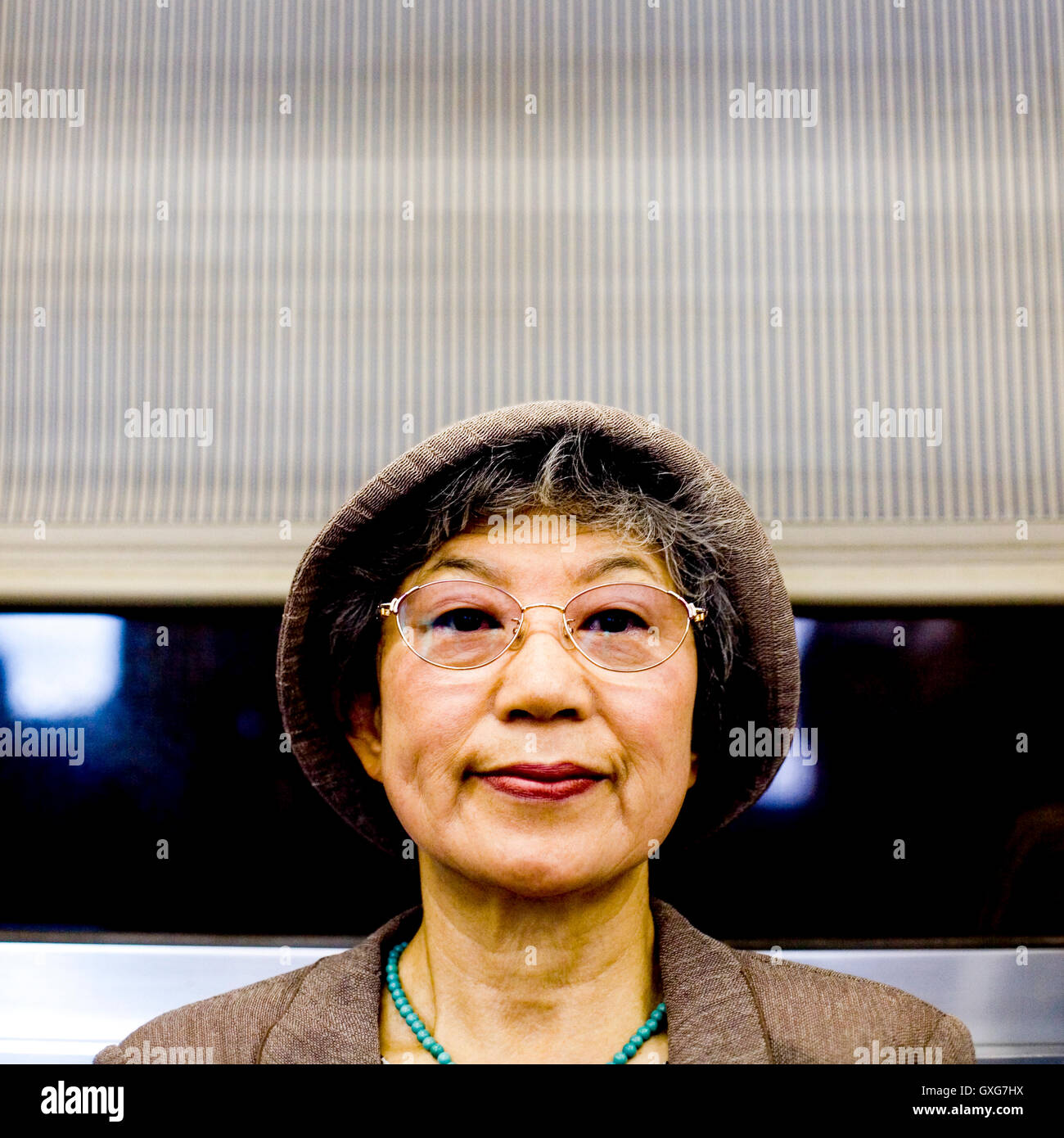 Serious Japanese woman wearing hat and eyeglasses Stock Photo - Alamy