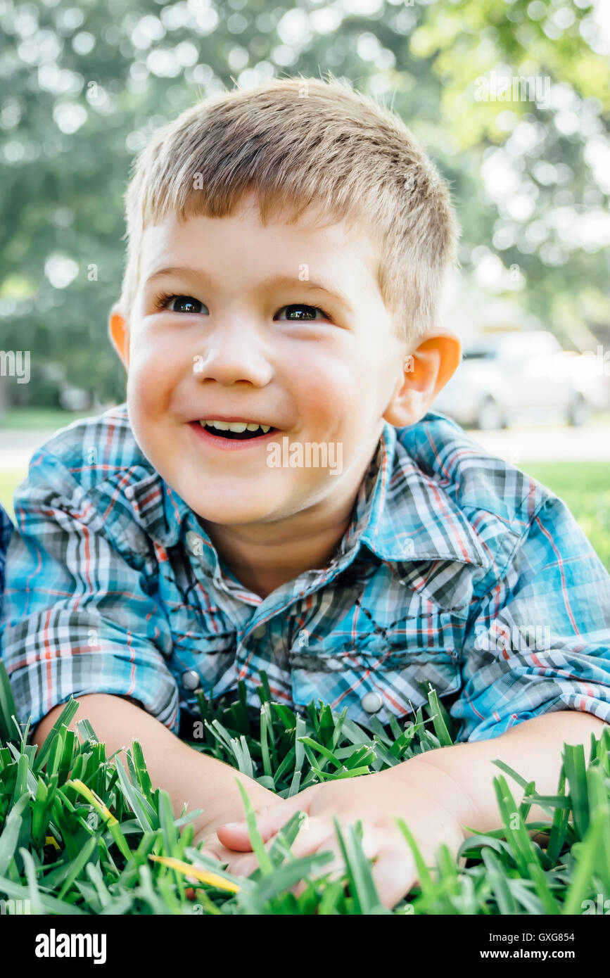 Smiling Caucasian boy posing in grass Stock Photo - Alamy