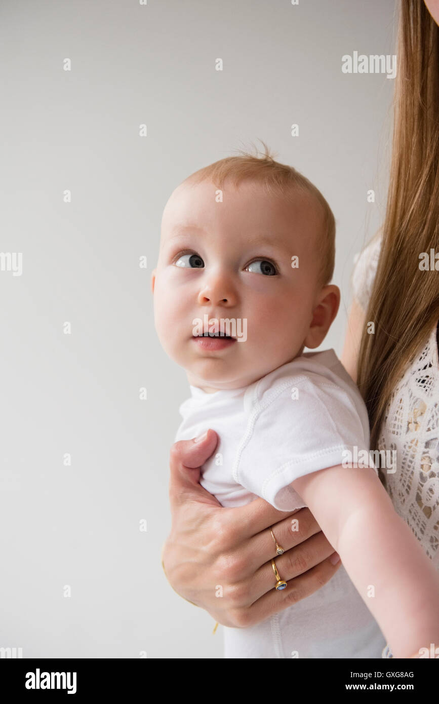 Caucasian baby boy looking back at mother Stock Photo - Alamy