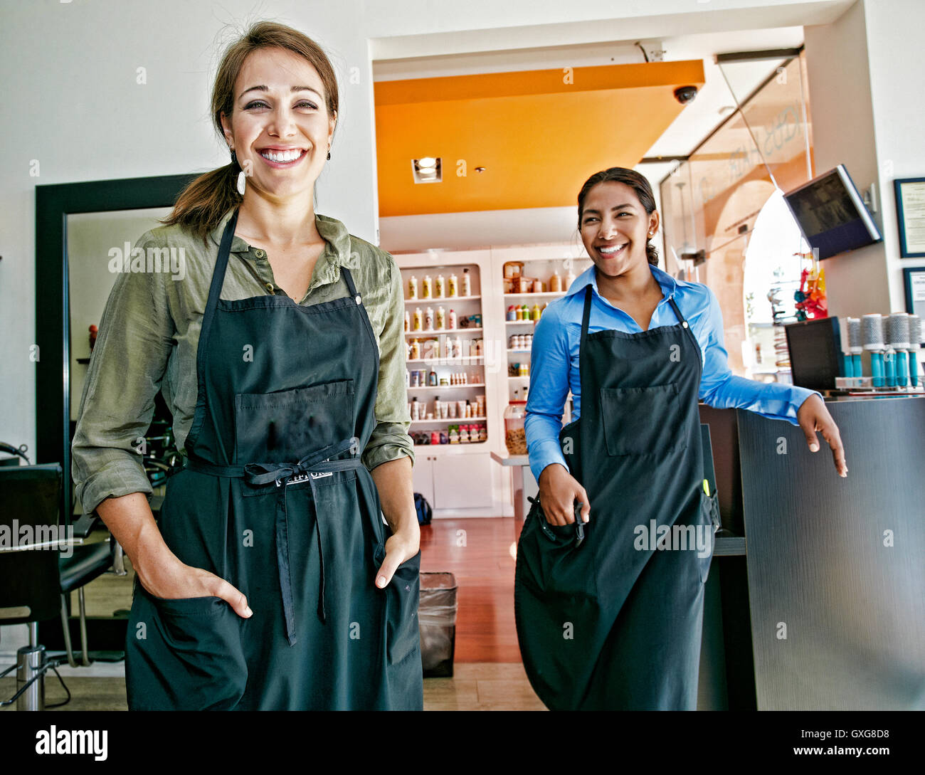 Smiling hairdressers posing in hair salon Stock Photo - Alamy