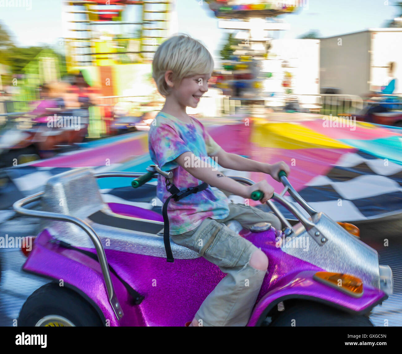 Child smiling on ride Stock Photo - Alamy