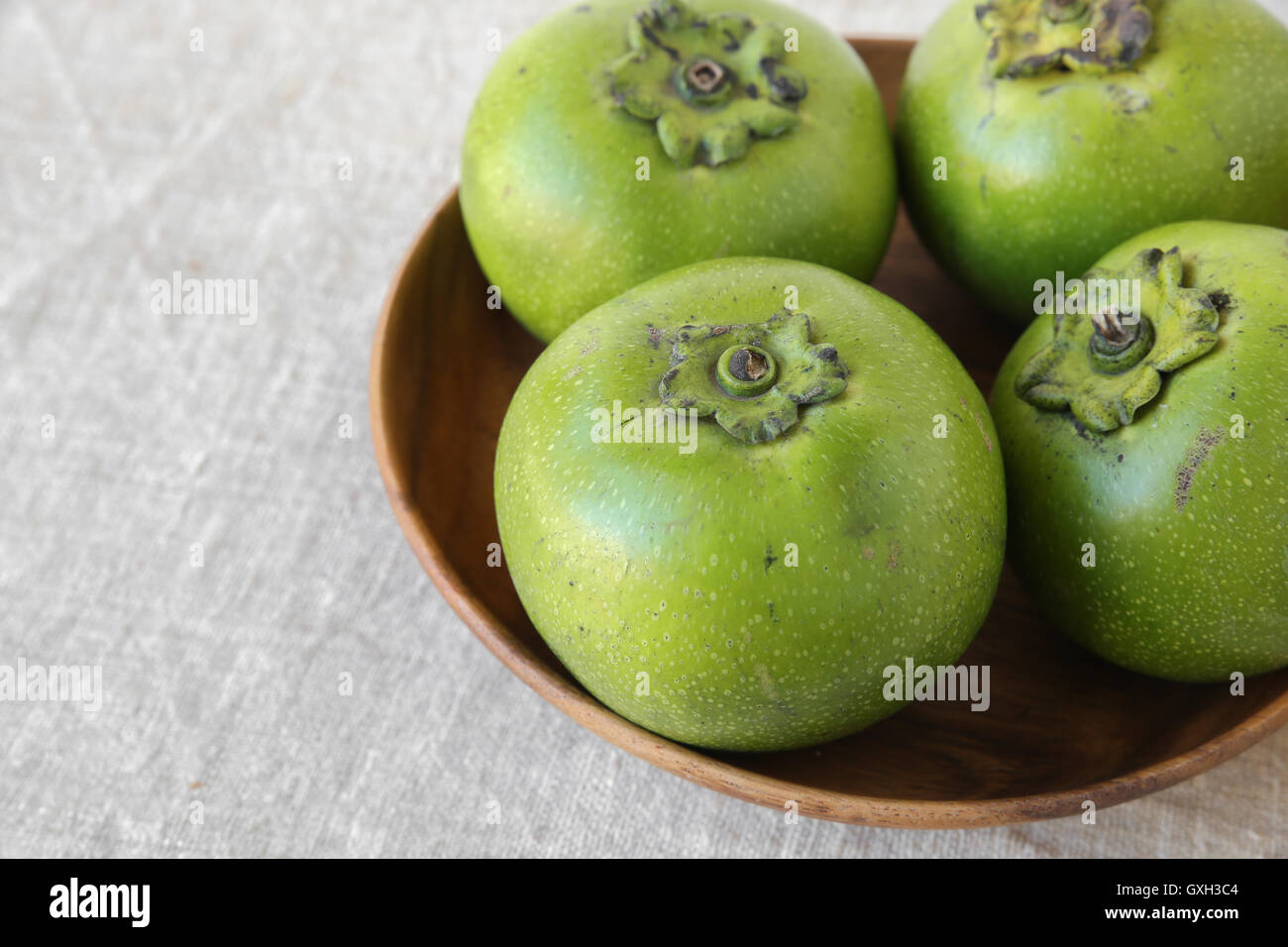 Sapote or black chocolate pudding fruit in wooden bowl Stock Photo - Alamy