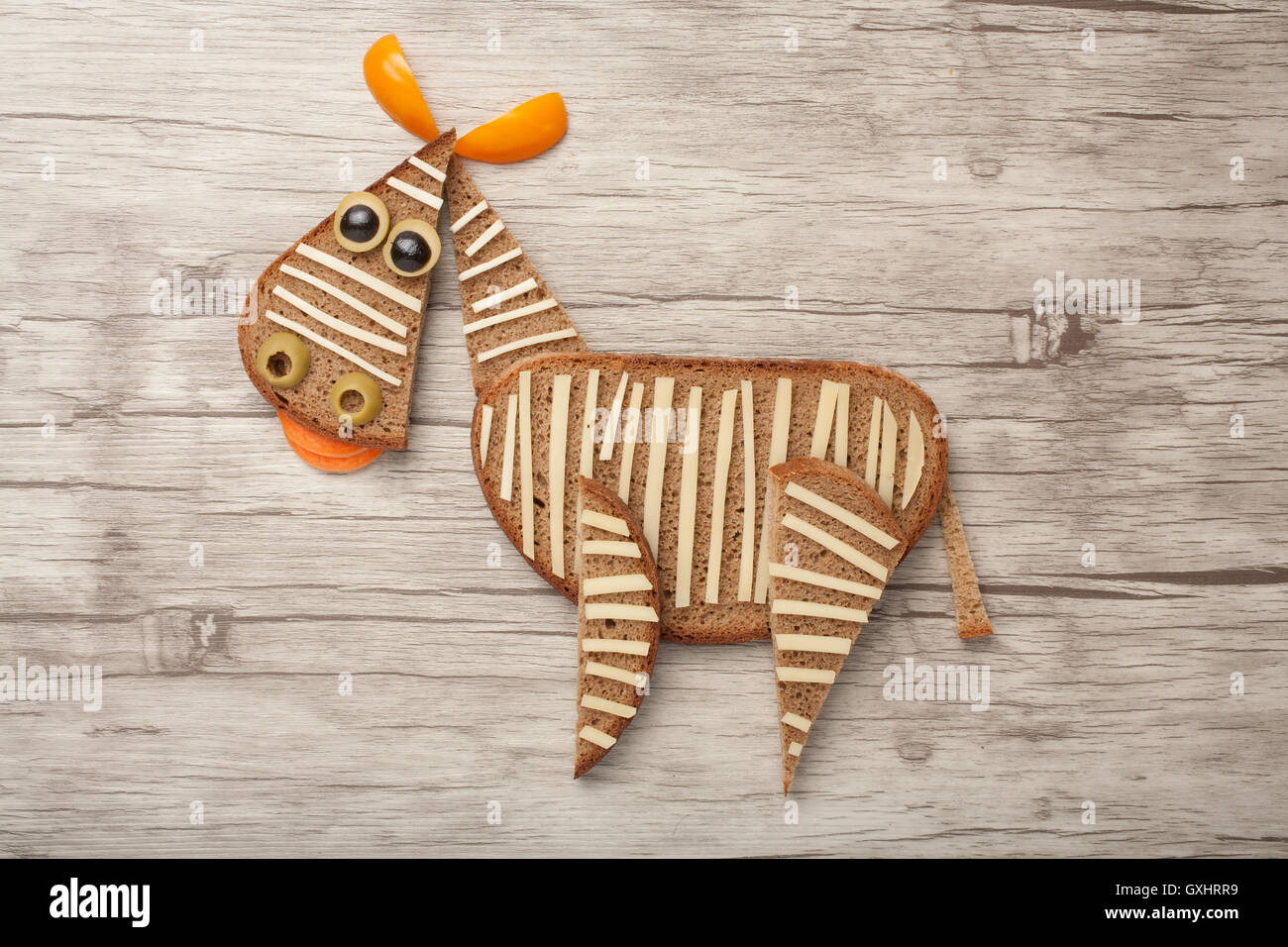 Funny zebra made of bread and vegetables on wooden background Stock ...