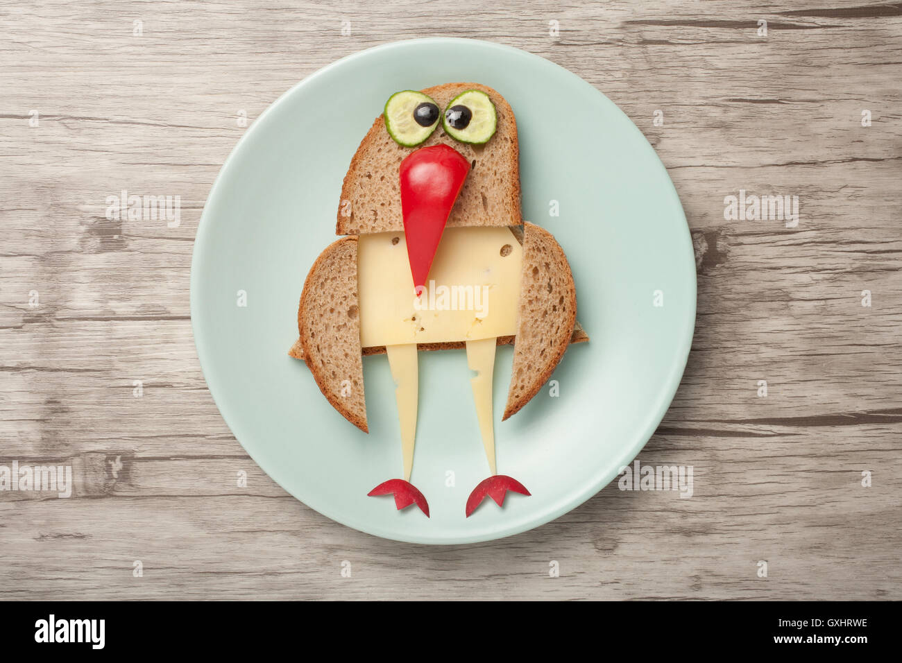 Confused bird made of bread and cheese on plate and desk Stock Photo ...