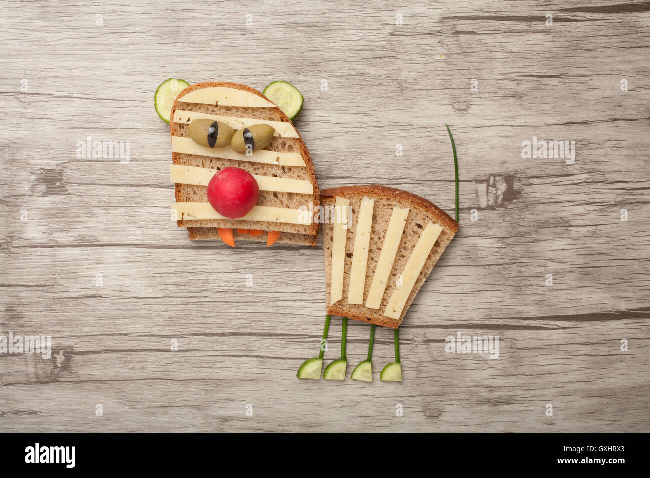 Tiger made of cheese and bread on desk Stock Photo - Alamy