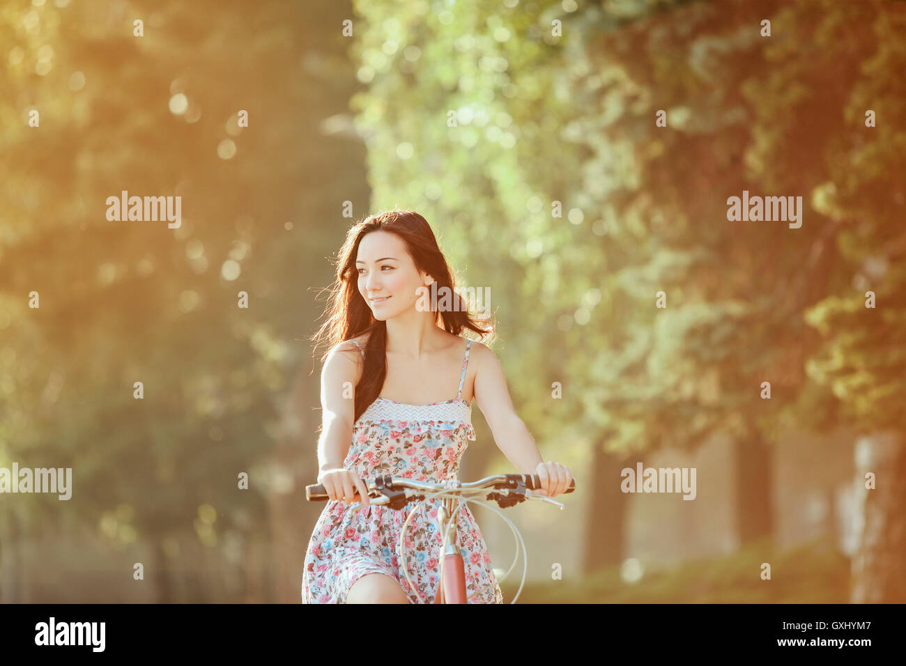The young girl with bicycle in park Stock Photo - Alamy