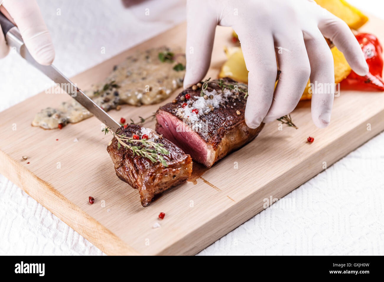 Chef at work, cutting steak slice Stock Photo - Alamy