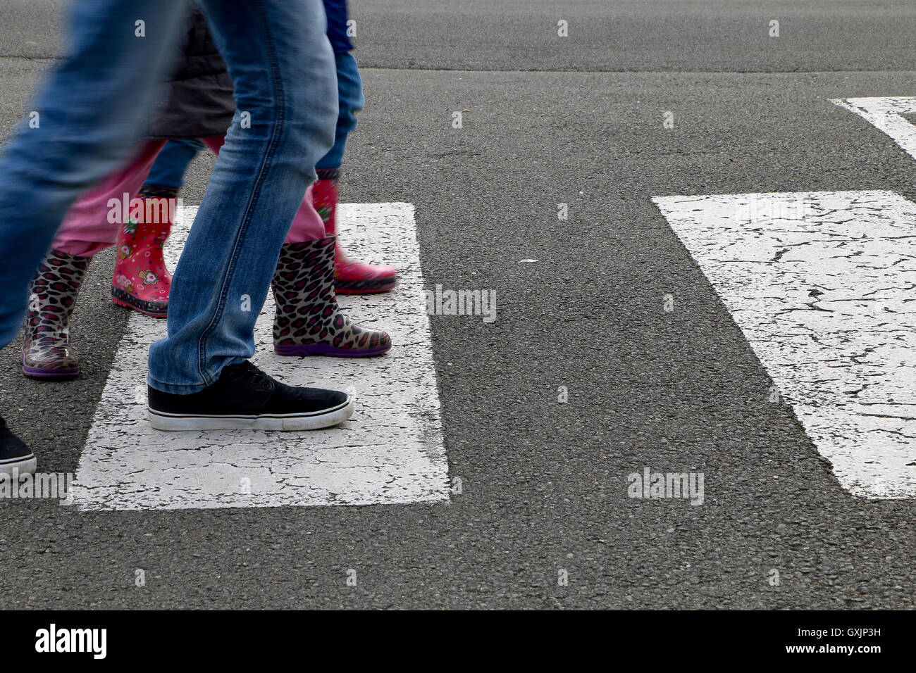 In the street, children crossing a crosswalk Stock Photo - Alamy