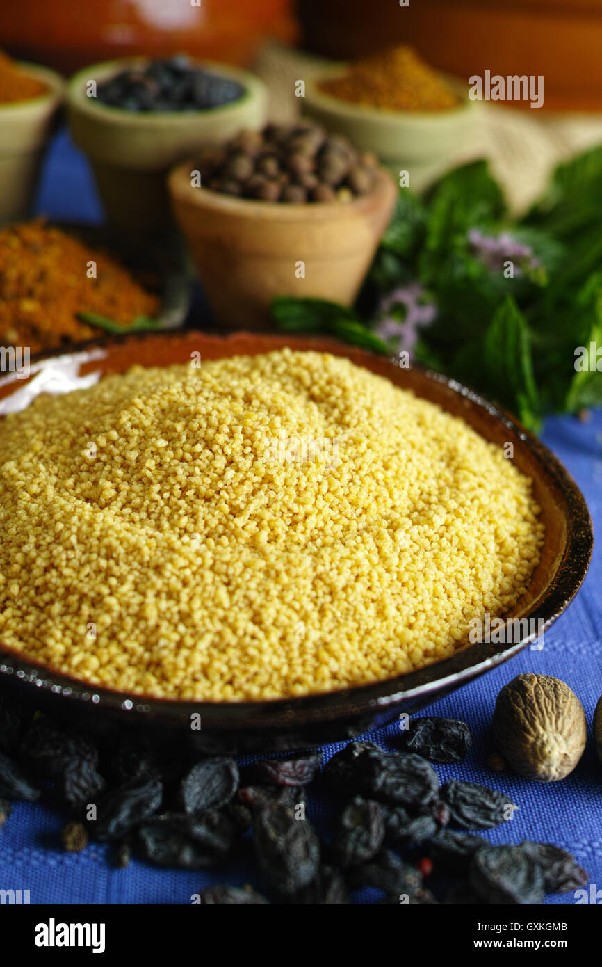 Organic couscous and different spices in traditional eastern clay bowls ...