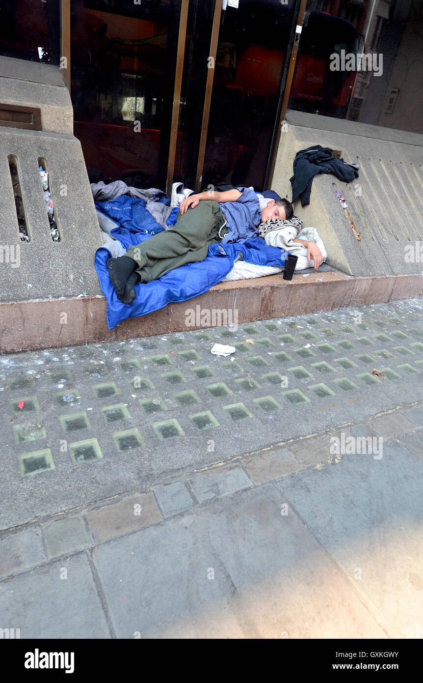 London, England, UK. Homeless man sleeping in a doorway in Whitehall ...