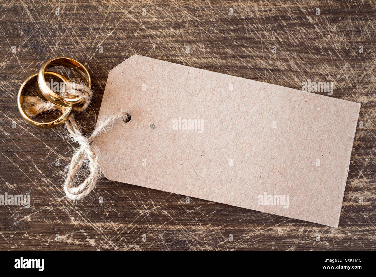 Wedding rings with blank tag on the wooden background Stock Photo - Alamy